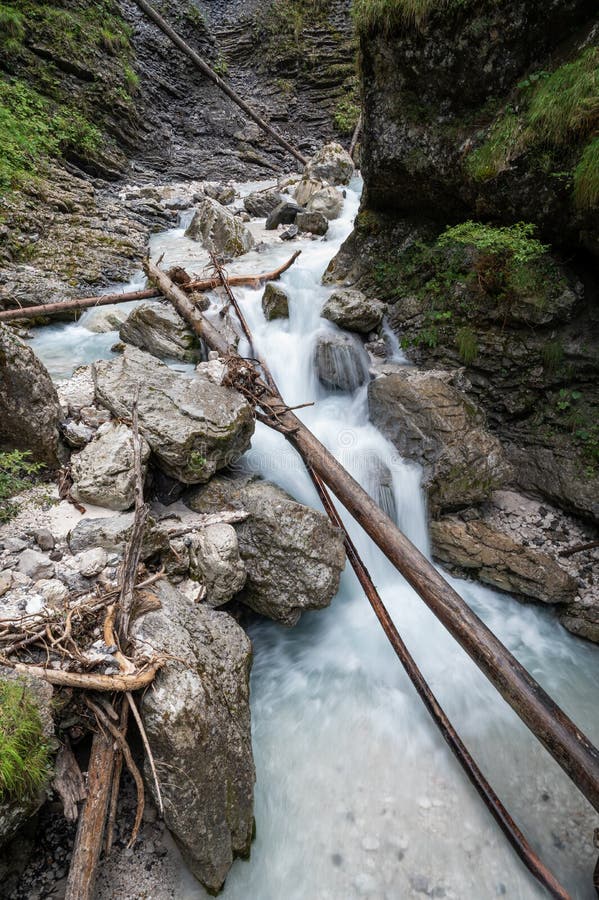 Long Exposure Image of Tree Logs Lying in Beautiful Stream of Water ...