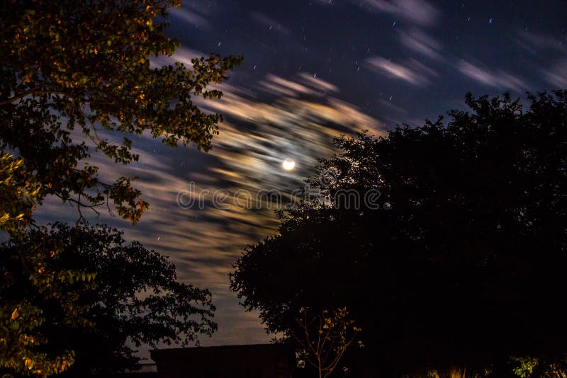 Long Exposure of Moon and Clouds with Stars Stock Image - Image of long ...