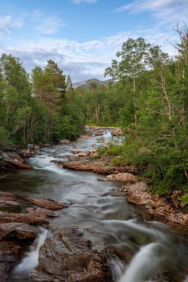 Long Exposure of a Picturesque Stream Flowing Over Rocks through a ...