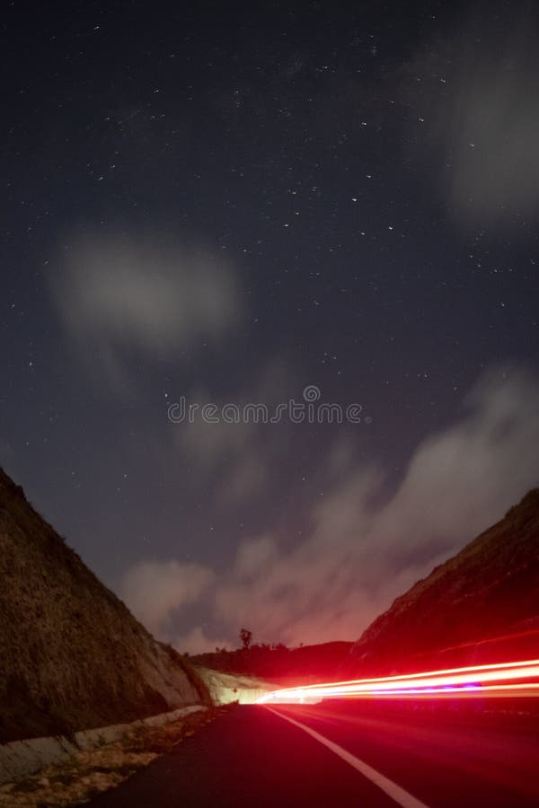 Long Exposure of a Red Light Trail of a Car Passing by Stock Image ...