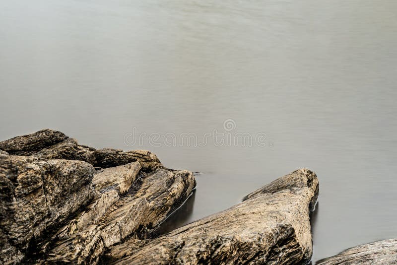Long Exposure of a River with Silk Effect in the Water, and Rocks in ...