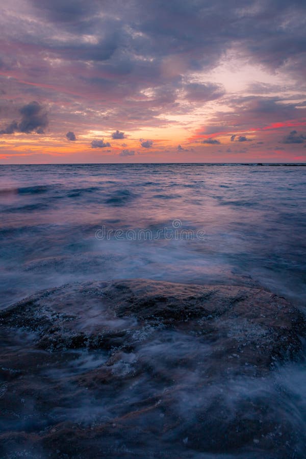 Long Exposure Sea and Rocks at Twilight Stock Photo - Image of rough ...