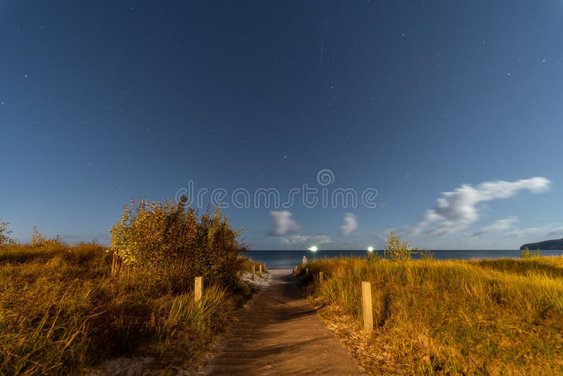 Long Exposure Shot of a Starry Night Sky Over a Beach Path in the ...