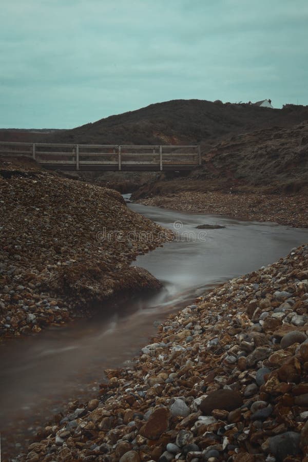 Long Exposure Shot of a Stream Running Underneath a Bridge Stock Image ...
