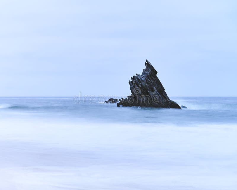Single Sharp Rock on the Middle of the Sea Stock Photo - Image of ...