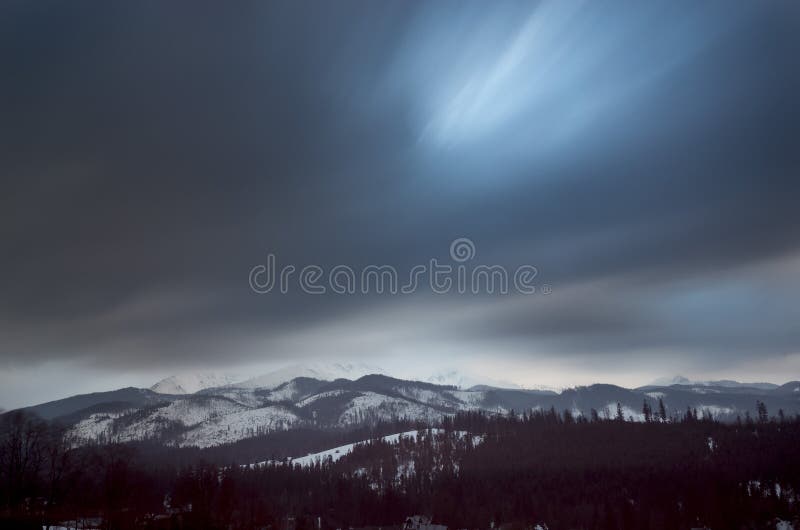 Long Exposure of the Snow-covered Mountains and a Cloudy Sky Stock ...