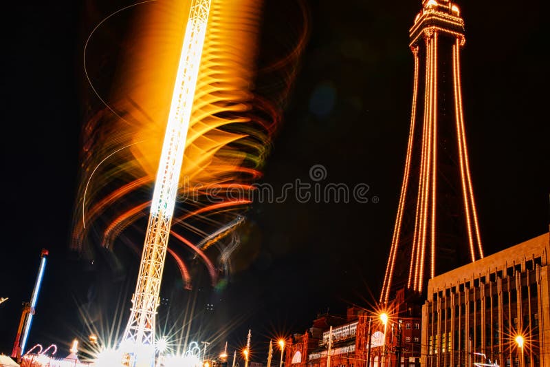 Long Exposure of a Spinning Carnival Ride at Night with Illuminated ...