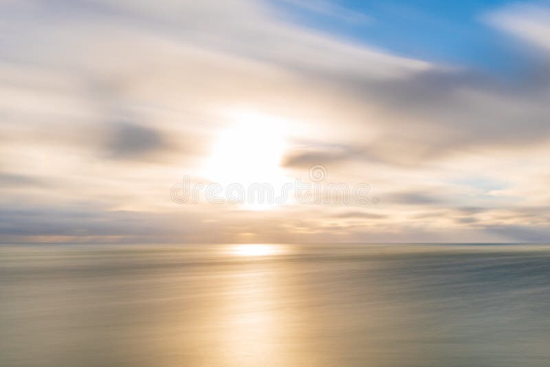 Long Exposure of the Sun, Clouds and Sea Stock Photo - Image of people ...