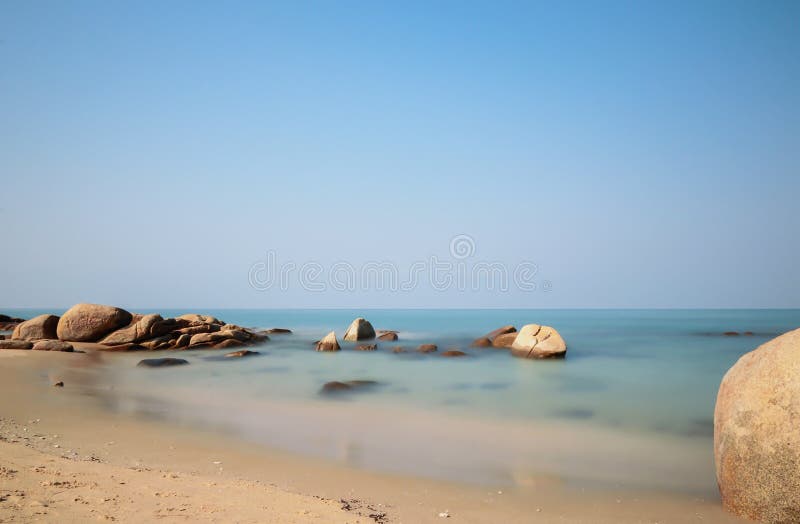 Long Exposure of Timber and Rock on the Beach Stock Photo - Image of ...