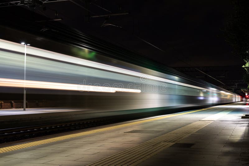 Long Exposure Train Running through the Station at Night Editorial ...