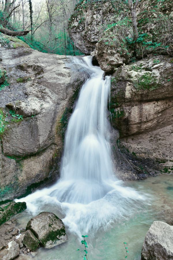 Long Exposure Waterfall Falling Down in the Middle of the Forrest in ...