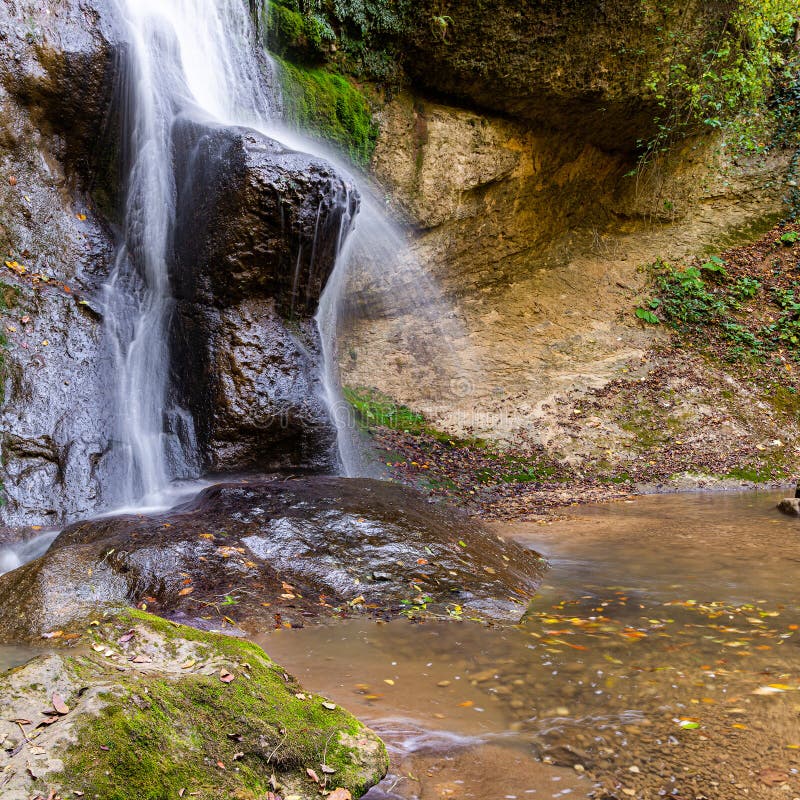 Long Exposure Waterfall Over Brown and Green Rocks Stock Image - Image ...