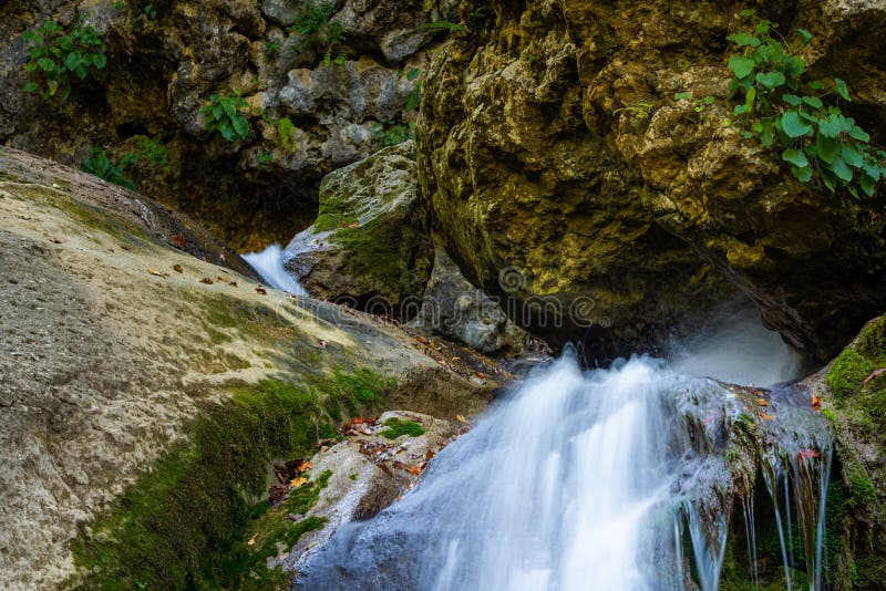 Long Exposure Waterfall Over Brown and Green Rocks Stock Image - Image ...