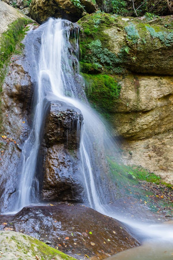 Long Exposure Waterfall Over Brown and Green Rocks Stock Image - Image ...