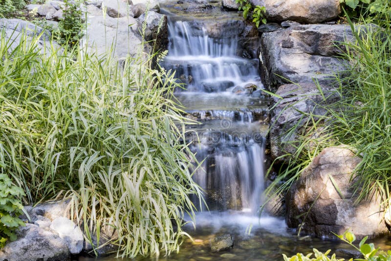 Long Exposure Waterfall in a Stream in a Garden Stock Image - Image of ...