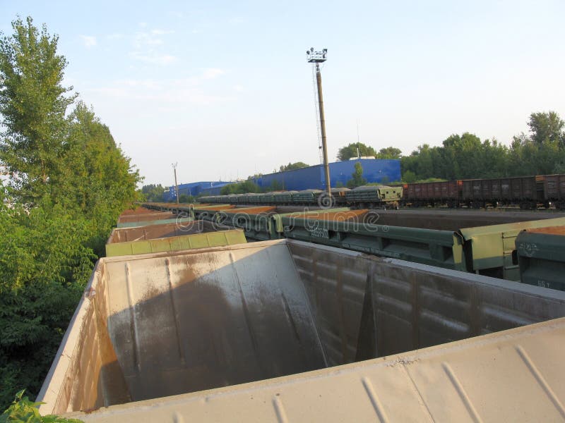 Long Freight Train with Open Containers Surrounded by Lush Greenery and ...