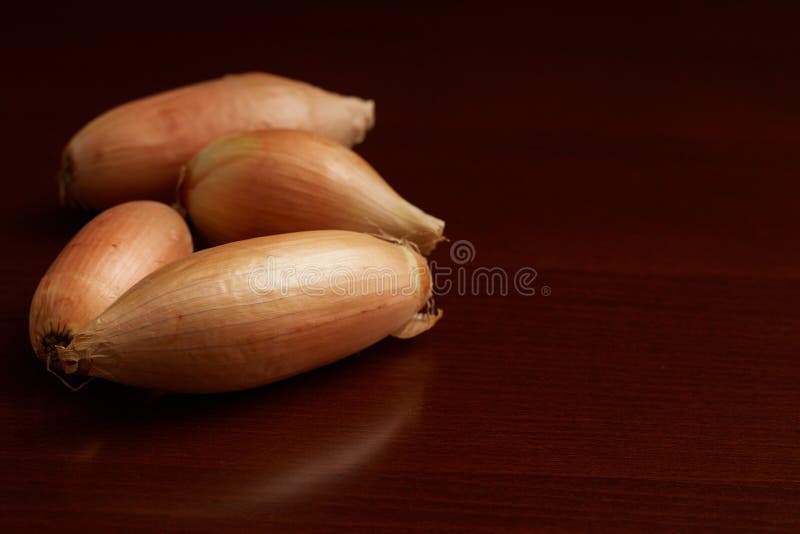 Long Golden Shallots on Brown Wood Table Stock Image - Image of healthy ...