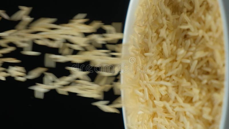 Long Grain Parboiled Basmati Rice Pouring on Black Background, Vertical ...