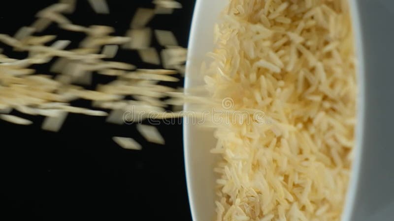 Long Grain Parboiled Basmati Rice Pouring on Black Background, Vertical ...