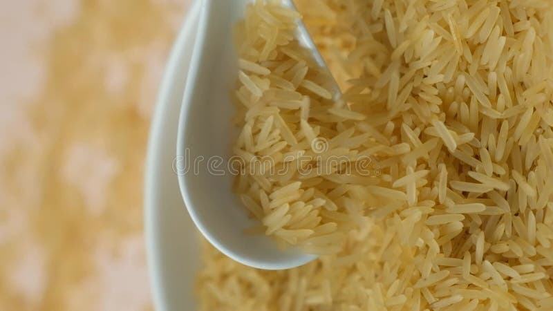 Long Grain Parboiled Basmati Rice Pouring with Spoon Macro Vertical ...