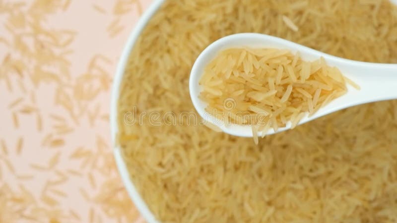 Long Grain Parboiled Basmati Rice Pouring with Spoon Top View Slow ...