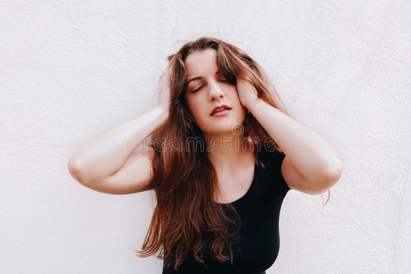 Long Hair Moody Girl Posing in Front of a White Wall Stock Photo ...