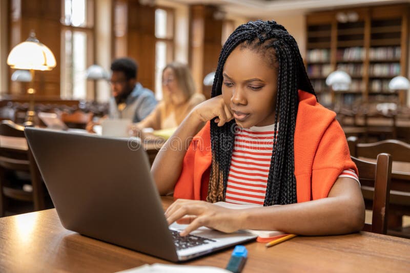 Long-haired African American Woman Working in the Library Stock Photo ...