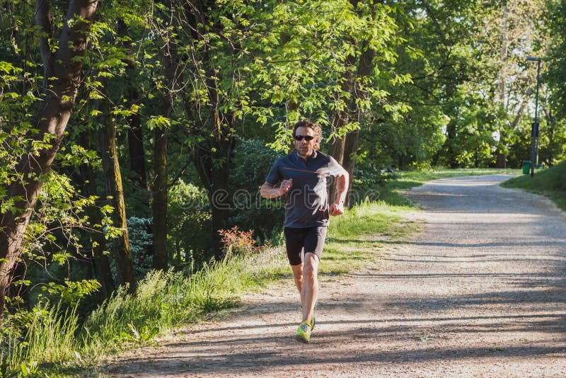 Long Haired Athlete Running in a City Park Stock Photo - Image of ...