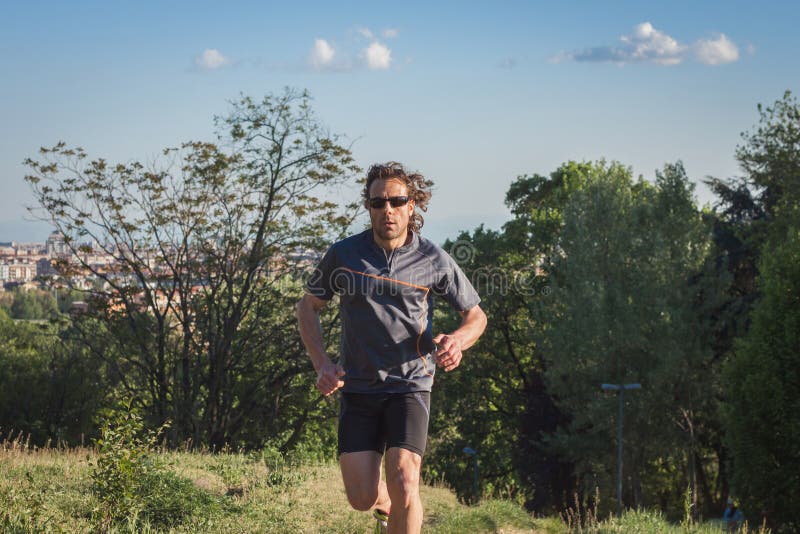 Long Haired Athlete Running in a City Park Stock Photo - Image of ...