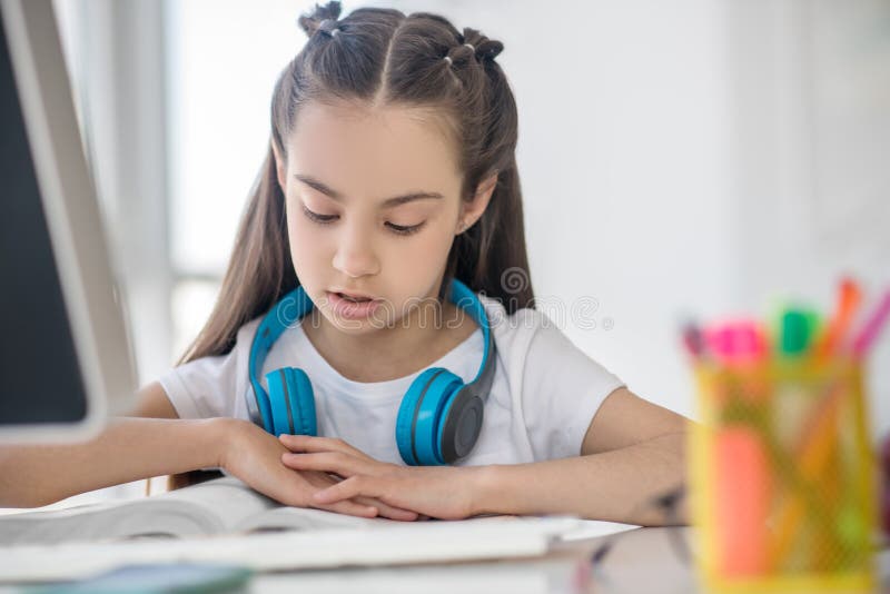 Long-haired Girl Doing Homework and Looking Involved Stock Image ...
