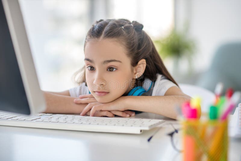 Long-haired Girl Sitting at the Table and Looking Thoughtful Stock ...