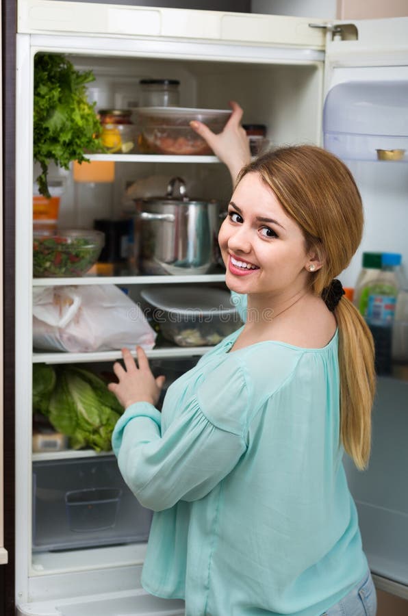 Long-haired Woman Arranging Space in Fridge at Home Stock Photo - Image ...