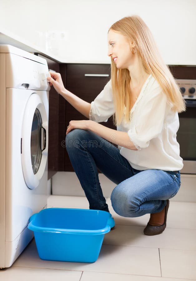 Long-haired Woman Doing Laundry with Washing Machine Stock Image ...