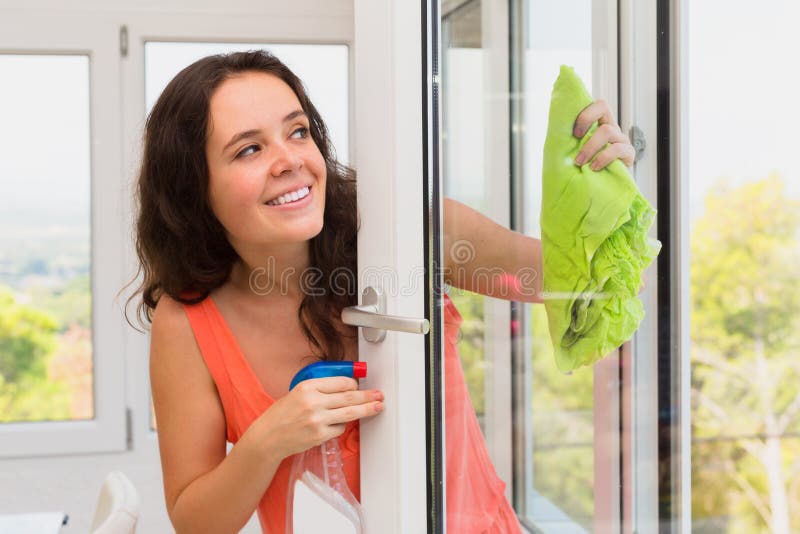 Long-haired Woman Washing Windows with Spray Stock Photo - Image of ...