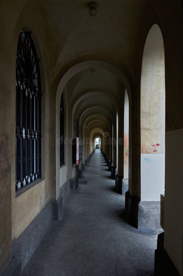 Long Hallway with Arched Windows and a Red Sign Editorial Photography - Image of medieval, empty ...