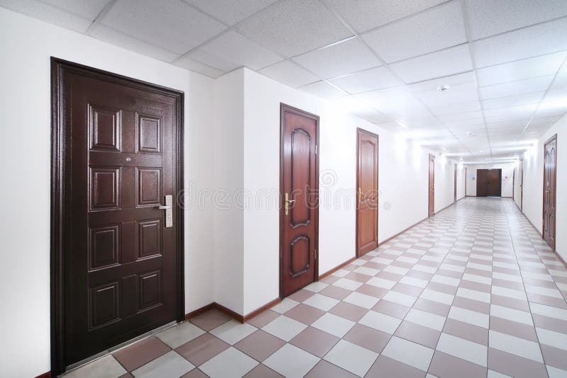 Long Hallway with Brown Wooden Doors Stock Image - Image of grey ...