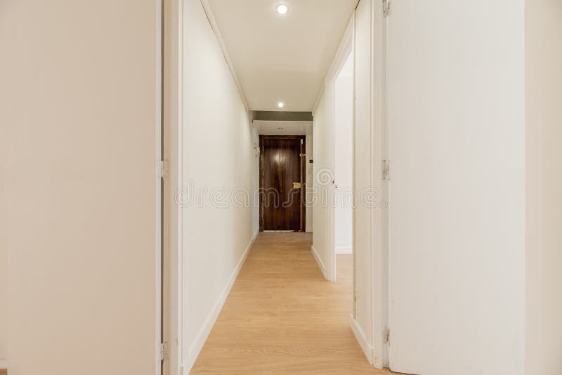Long Hallway of an Empty Residential Home with Oak Floorboards Stock ...