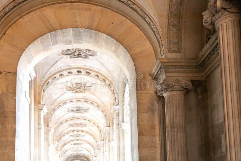 A Long Hallway Features Many Arches and Columns in a Major Building ...