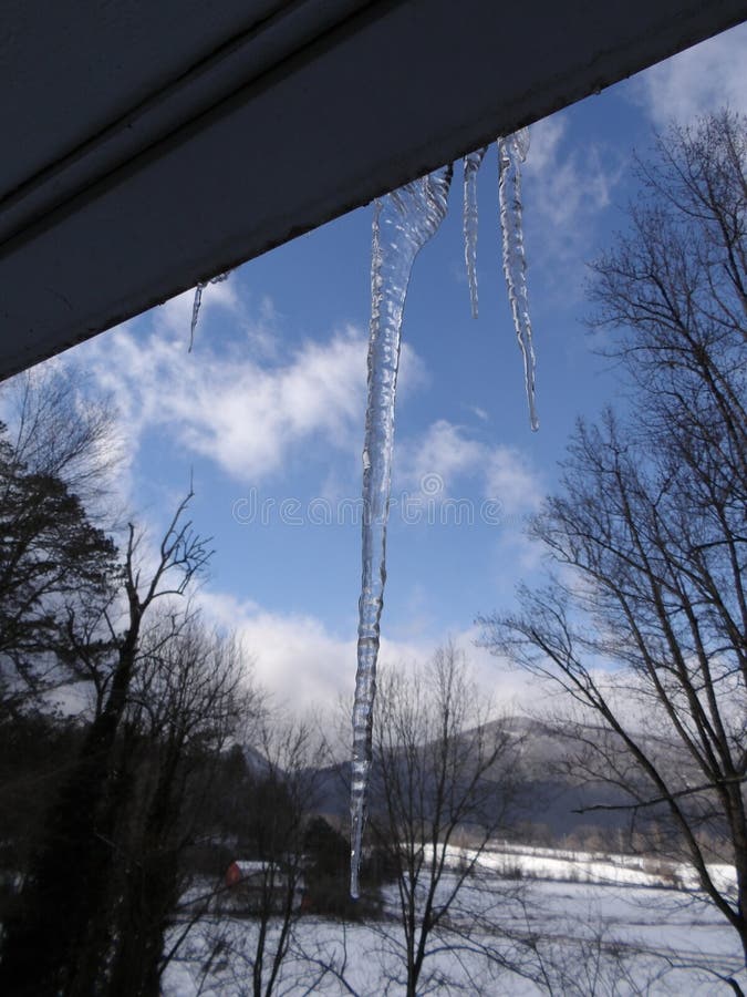 Long Icicle with Snowy Mountains Stock Image - Image of cloud, sunlight ...
