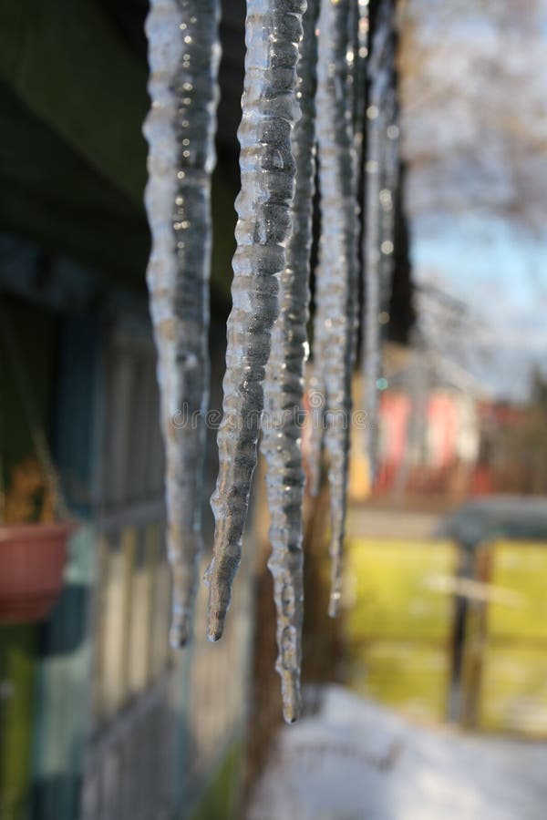 Long Icicles Hanging from the Roof Line Stock Photo - Image of frost ...