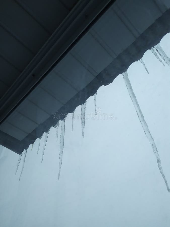Long Icicles Hanging on the Roof, View from Below Stock Photo - Image ...