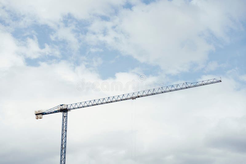 Long Industrial Crane Behind a Building in Clear Sky Background Stock ...