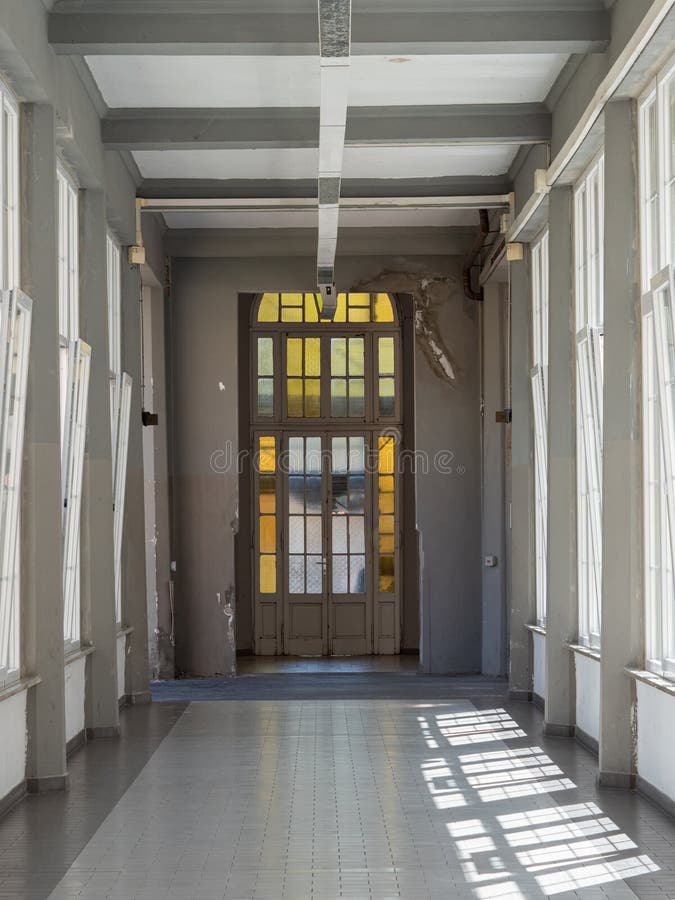 Long Interior Corridor of a Hospital with Large Windows and People ...