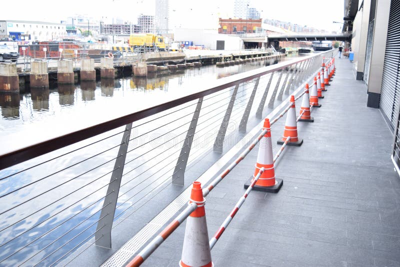 Long Line of Red Cones Next To a Metallic Bridge Stock Photo - Image of ...