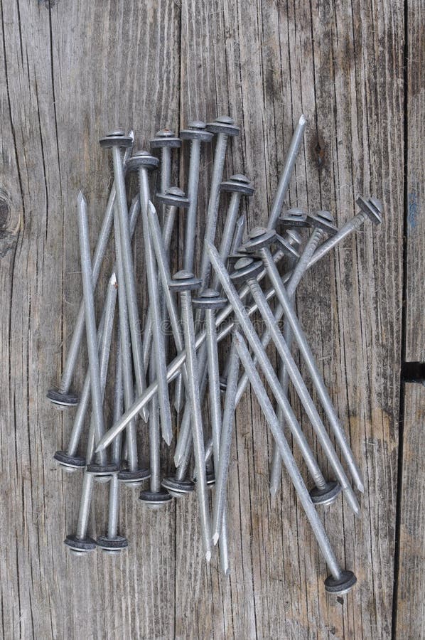 Long Metal Nails on a Gray Wooden Table Stock Photo - Image of long ...