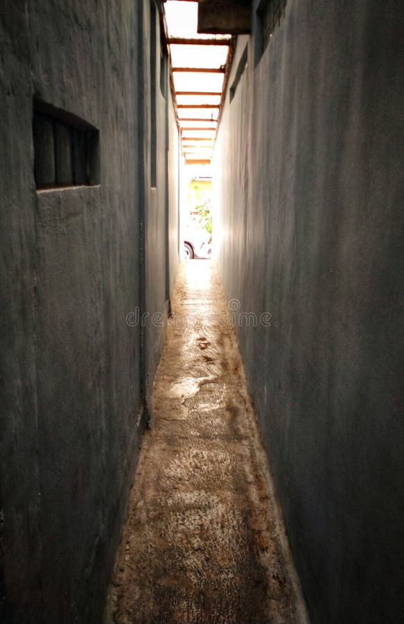 A Long, Narrow Hallway with a Open Door in the Middle. the Hallway is ...