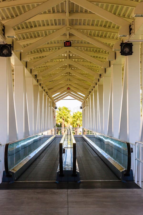 A Long, Narrow Walkway with Escalators and a Sign that Says "Exit Stock ...