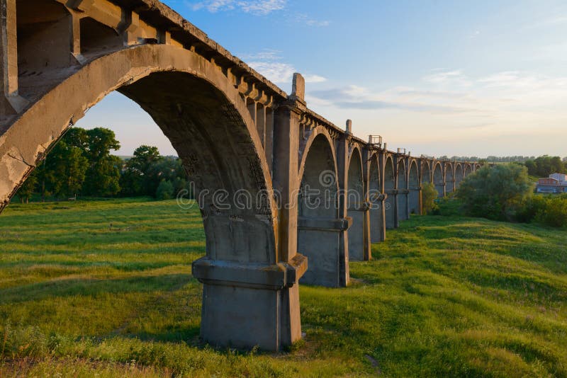 Long Old Arched Railway Bridge Over a Green Ravine on a Summer Evening ...