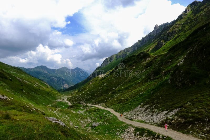 Long Path with Colorful Hikers in the Mountains Stock Photo - Image of ...