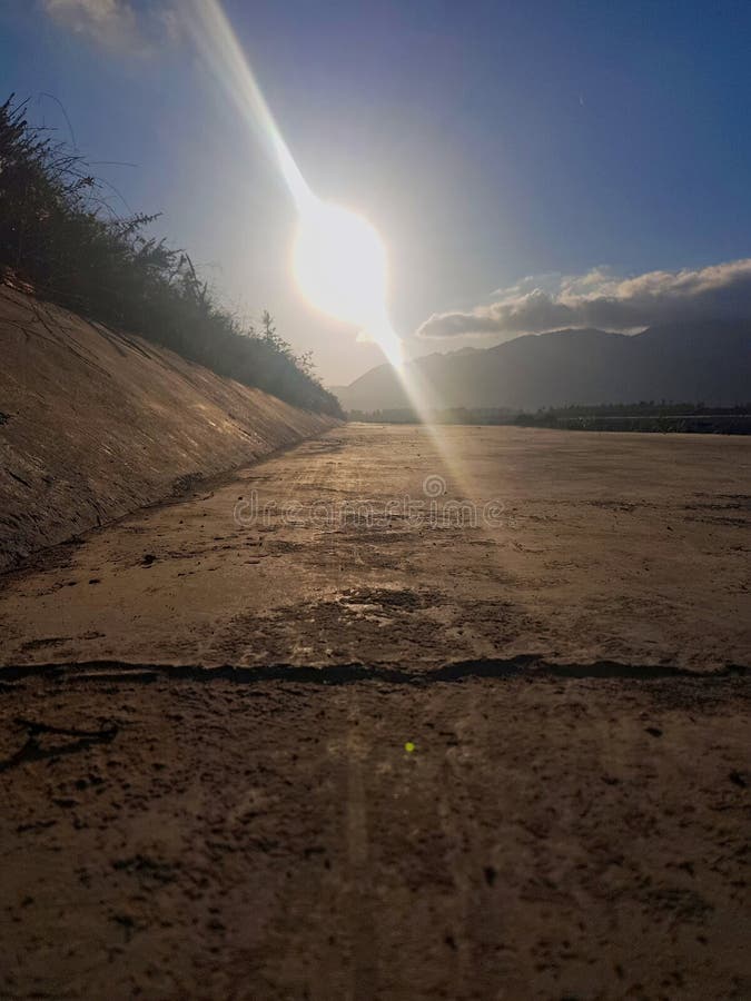 Long Path by the River at Sunset. the Sky Glows As the Sun Casts Warm ...